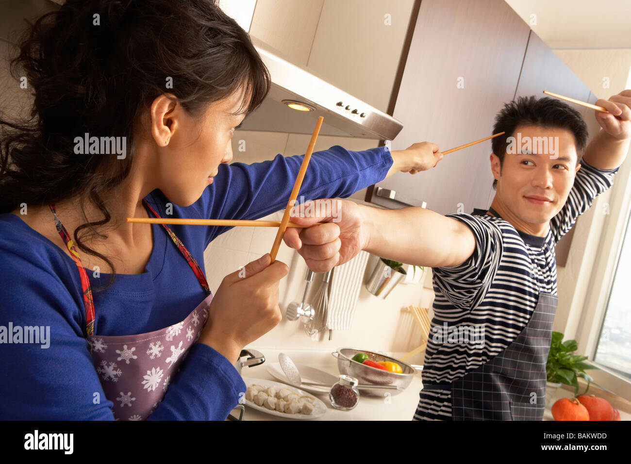 Young Couple Have A Sword Fight With Chop Sticks Stock Photo - Alamy