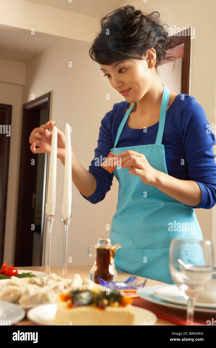 Woman Lighting Candles Stock Photo - Alamy