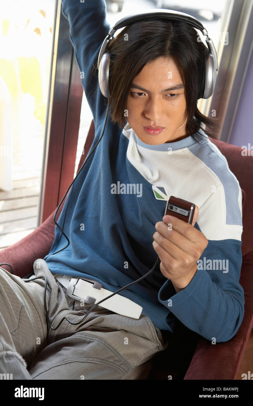 Young Man Listening To Mp3 Player Stock Photo - Alamy