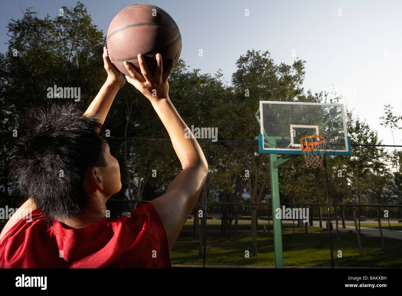 Basketball Player Shooting Hoops Stock Photo - Alamy