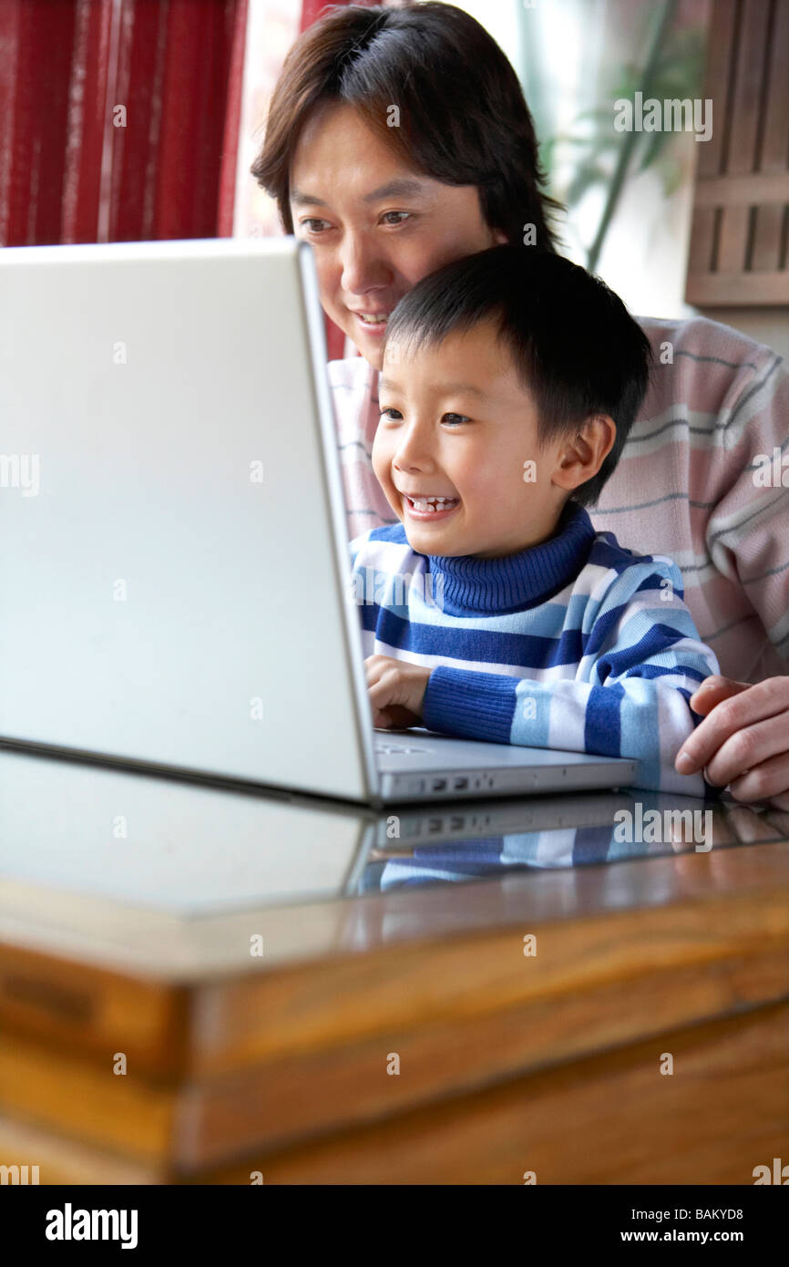 Father and son using laptops hi-res stock photography and images - Alamy
