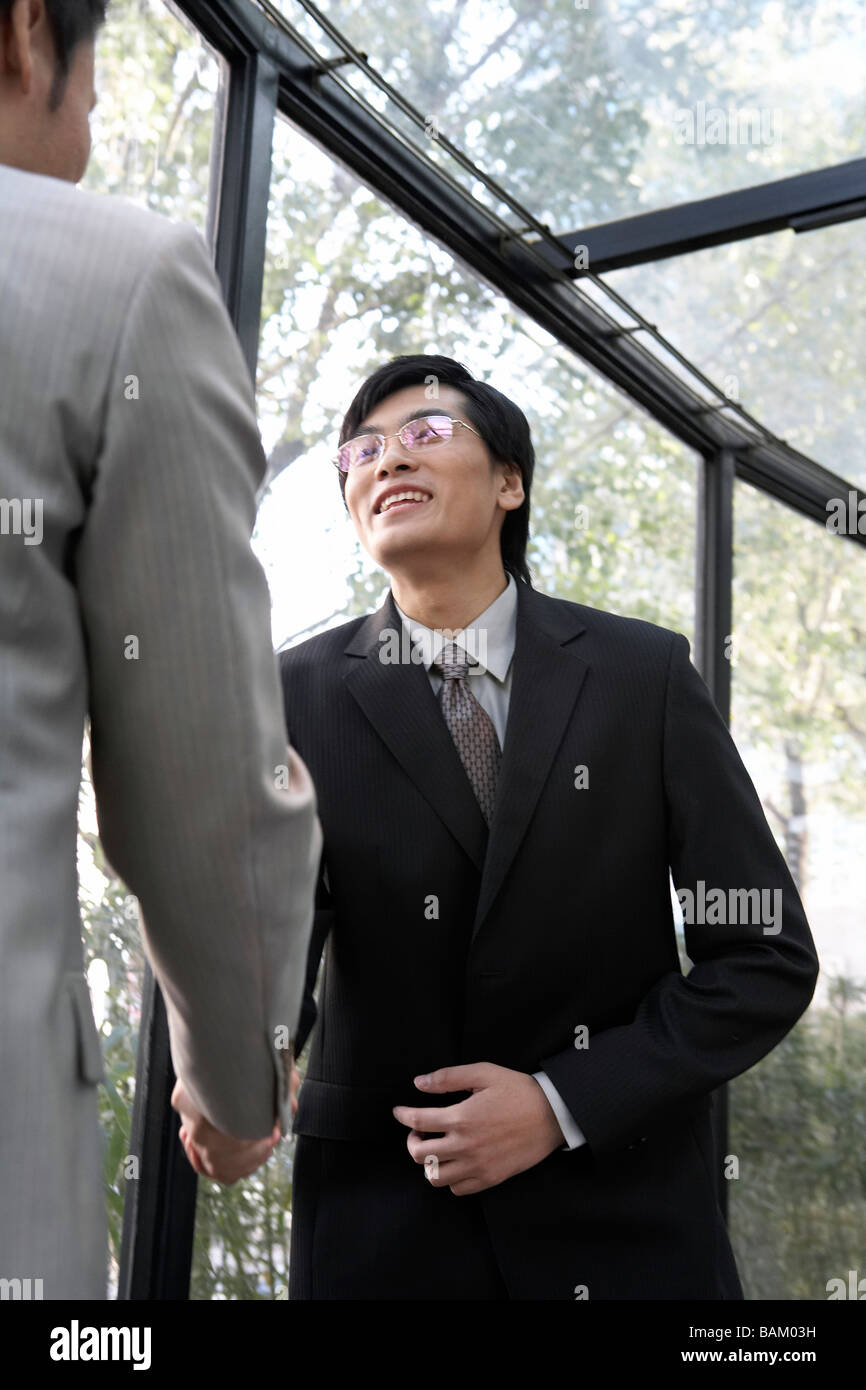 Two Businessmen Greeting Each Other Stock Photo - Alamy