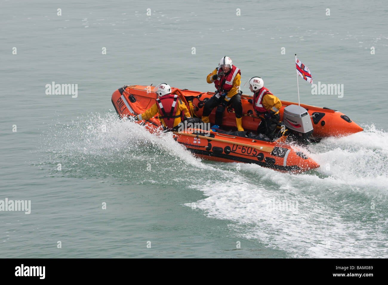 RNLI (Royal National Lifeboat Institution) crew members in a boat ...
