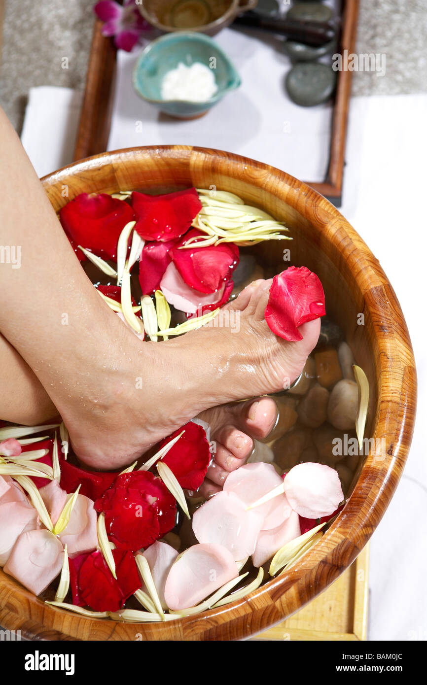 Feet In A Bucket Of Water With Flower Petals Stock Photo - Alamy