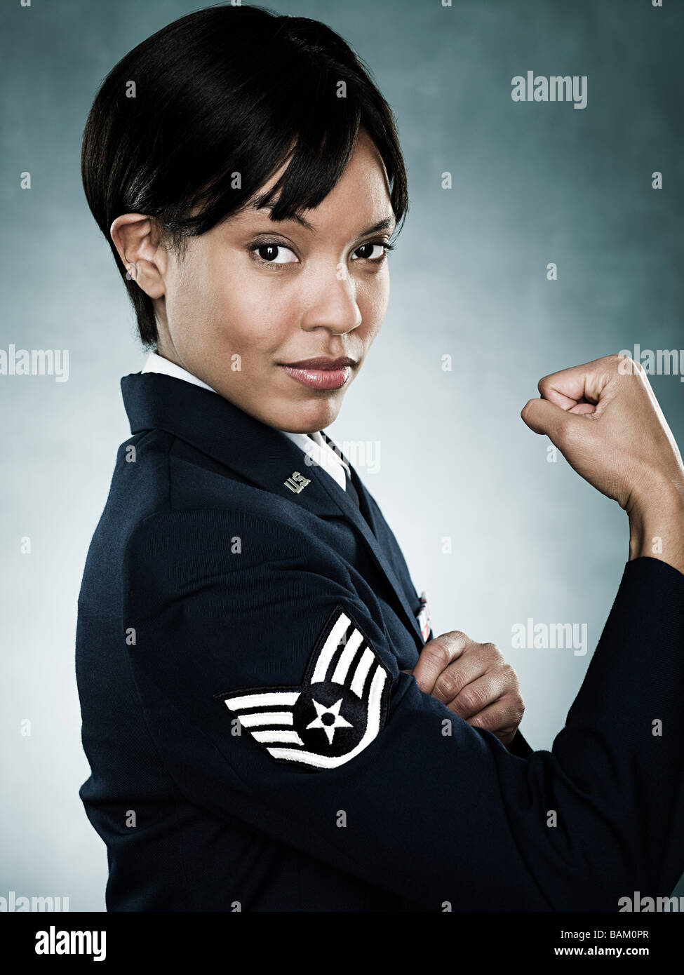 Portrait of an air woman flexing her muscles Stock Photo - Alamy