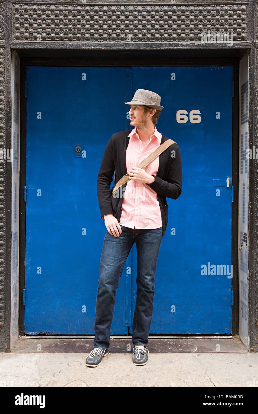 Young man by door Stock Photo - Alamy