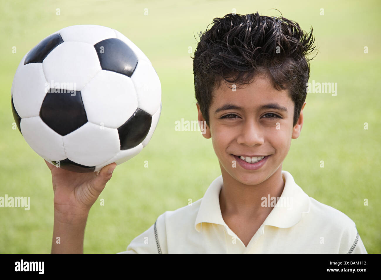 Portrait of a boy holding a football Stock Photo - Alamy