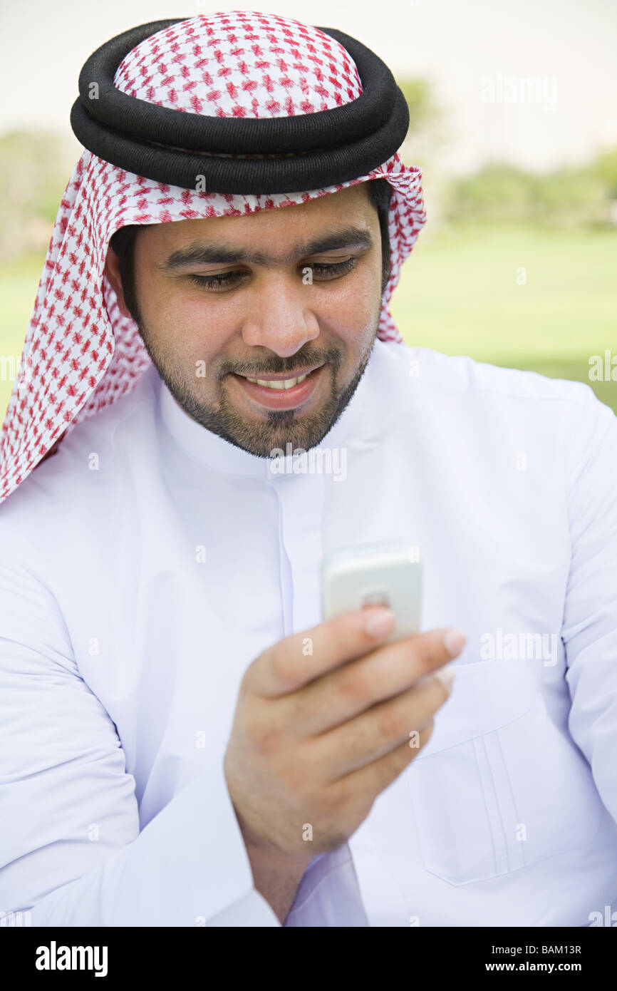 A young man using his cell phone Stock Photo - Alamy