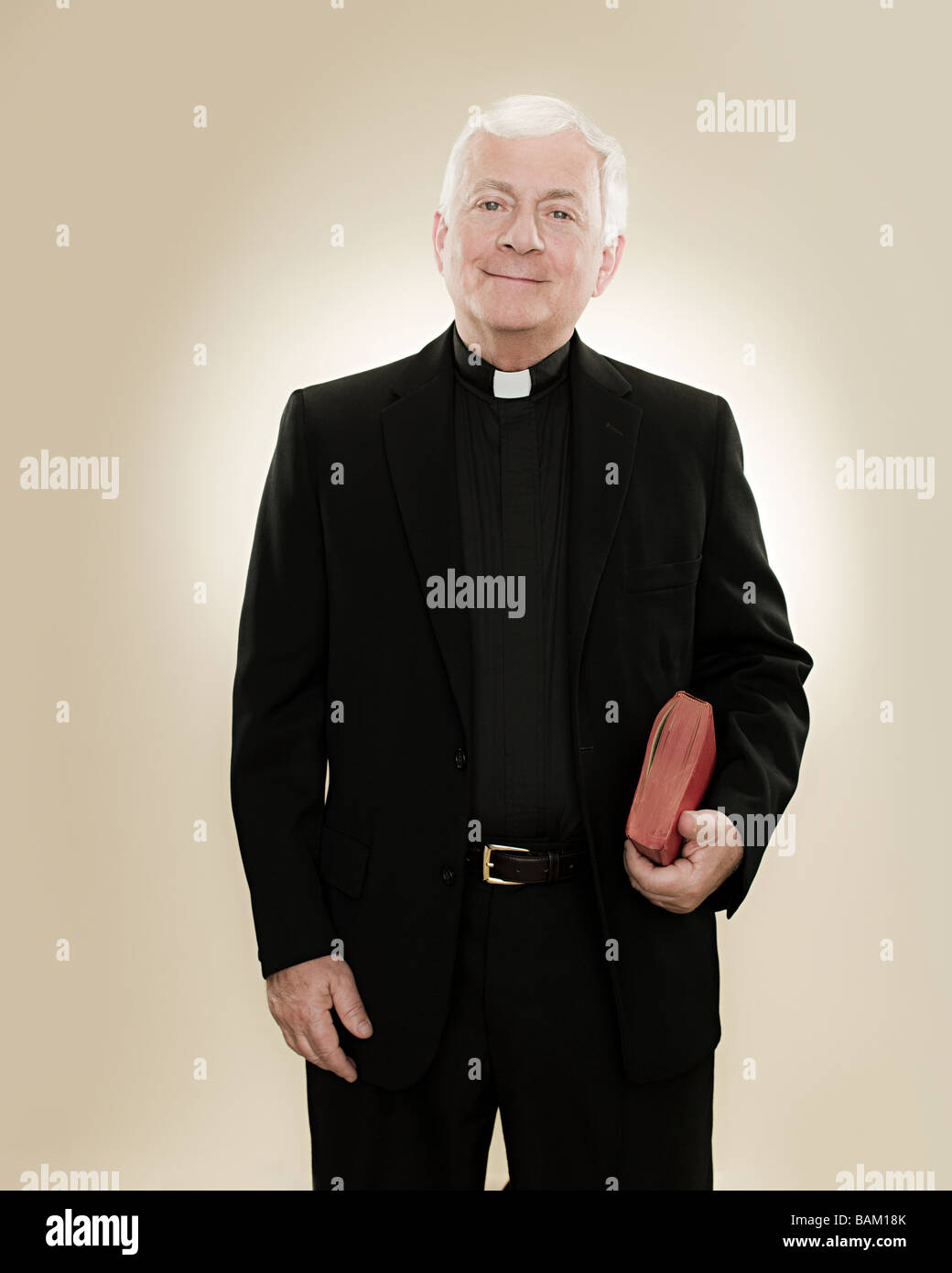 Portrait of a priest holding a bible Stock Photo - Alamy