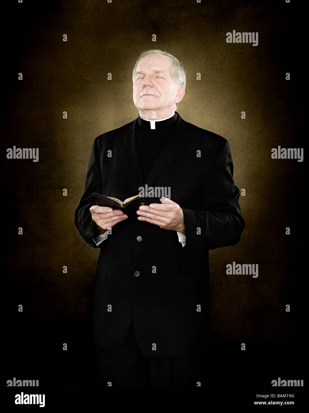 A priest holding a bible Stock Photo - Alamy