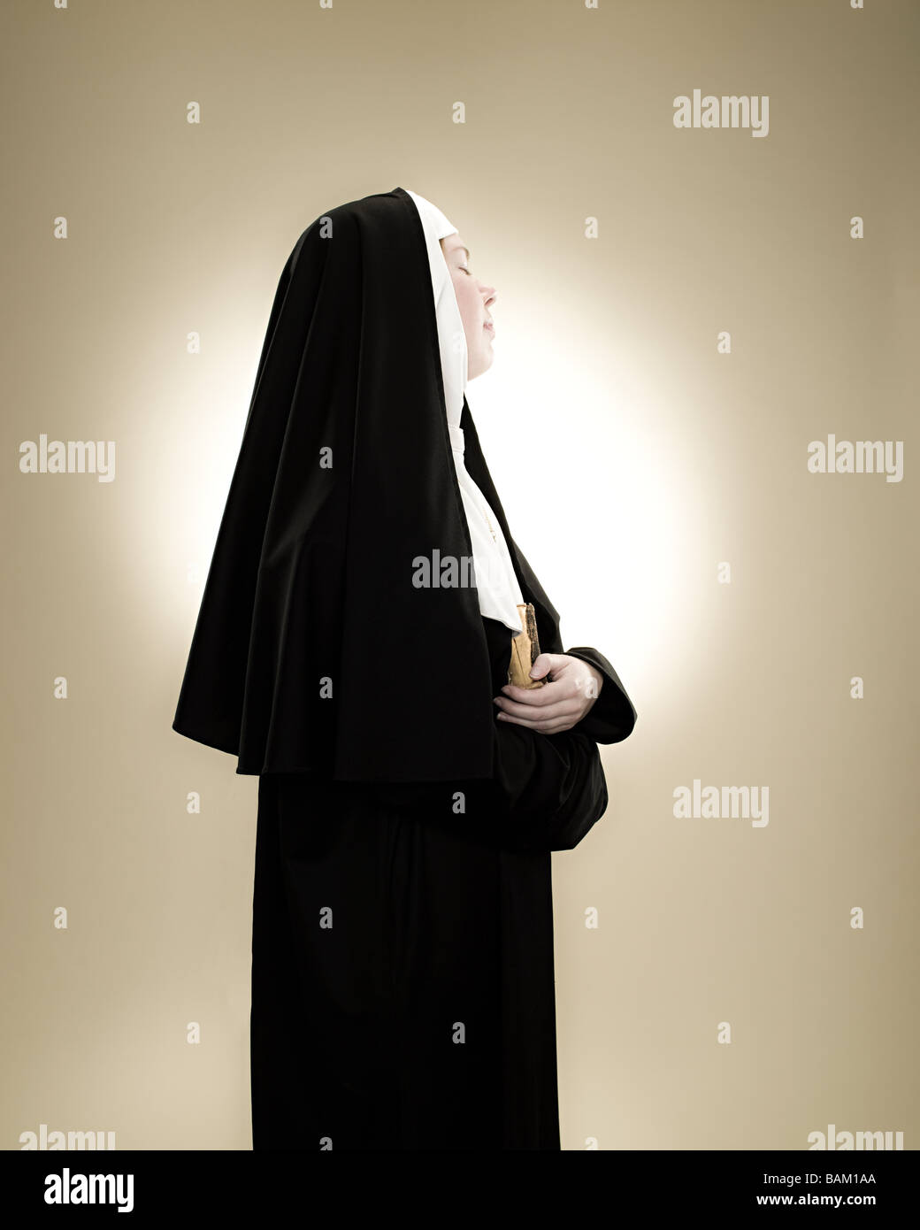 Profile of a nun holding a bible Stock Photo - Alamy