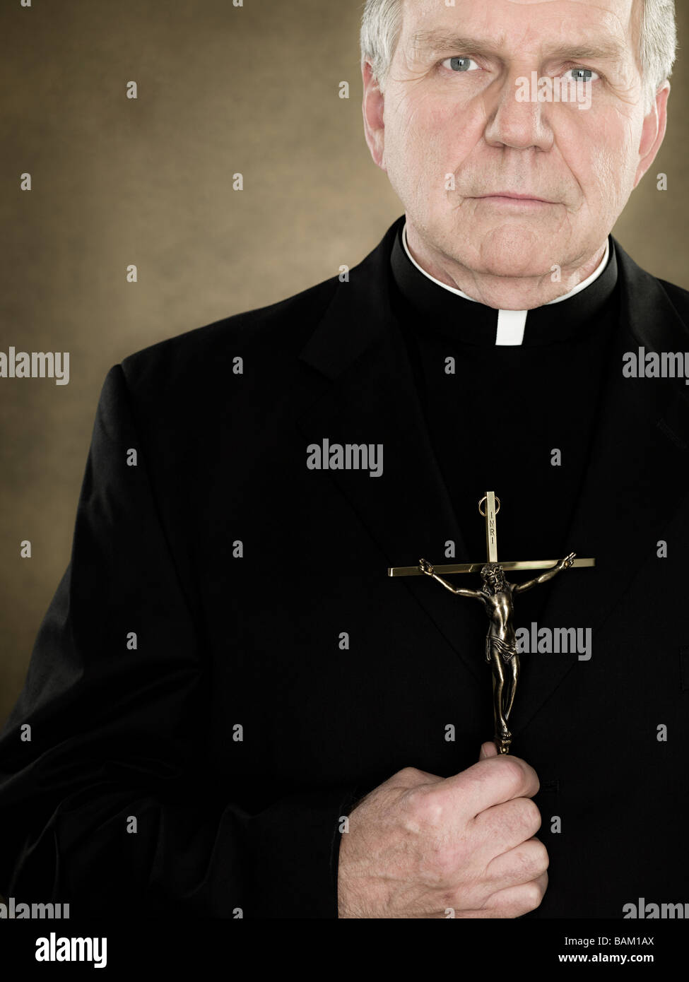 Priest holding cross hi-res stock photography and images - Alamy