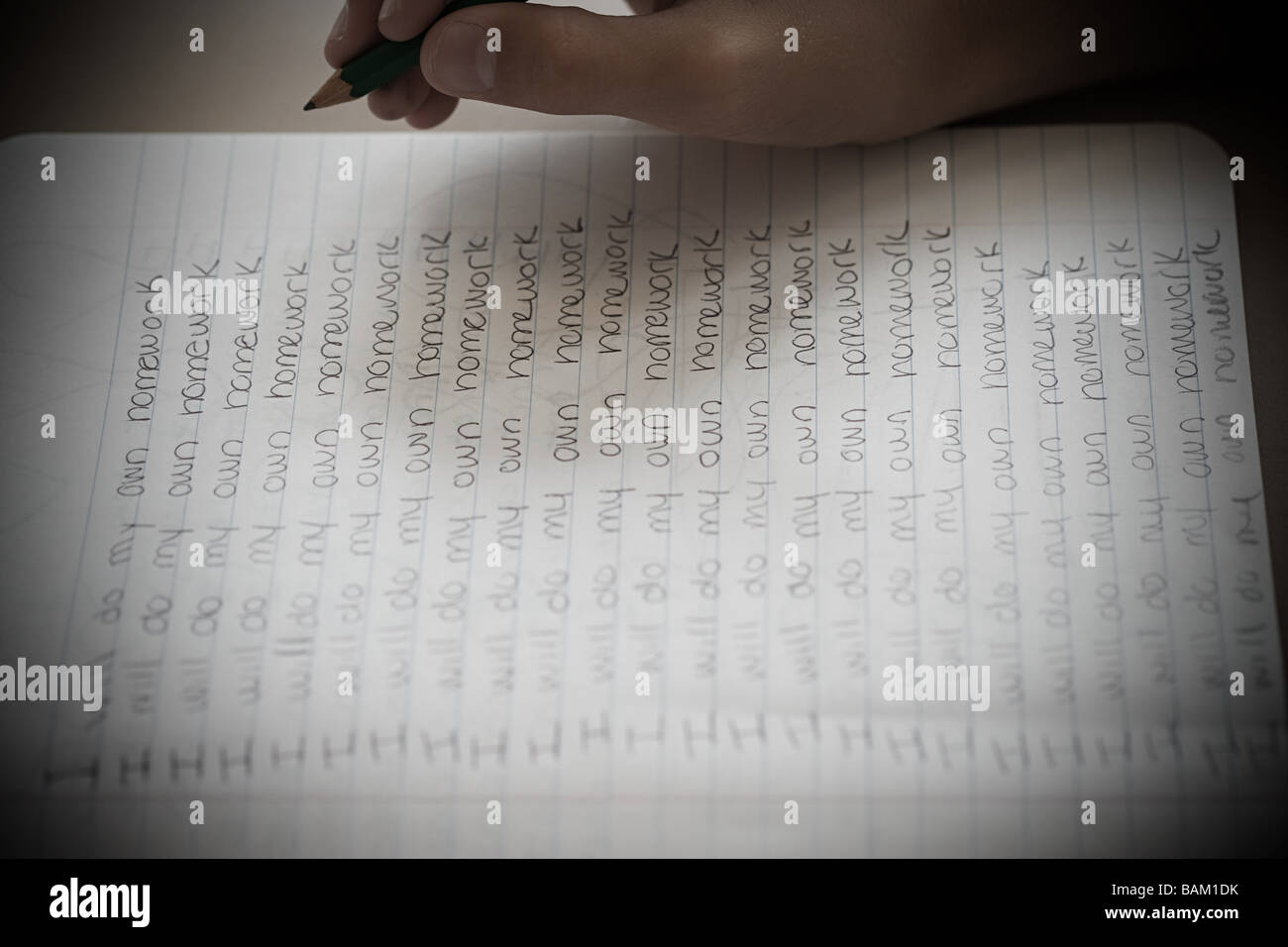 School student writing lines Stock Photo - Alamy