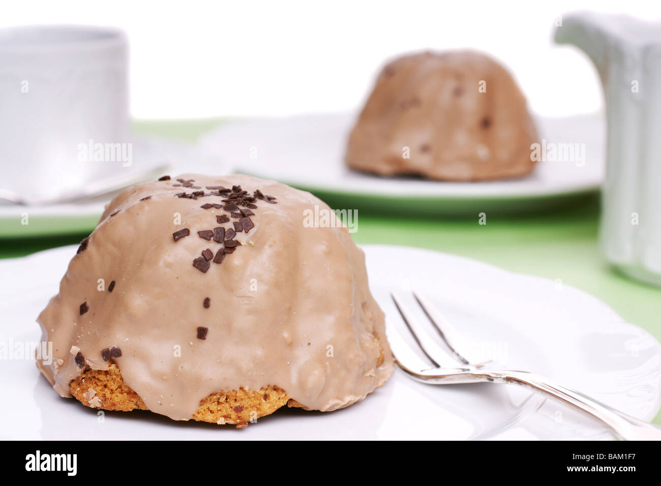 Two little cupcakes with chocolate frosting on a table Stock Photo - Alamy
