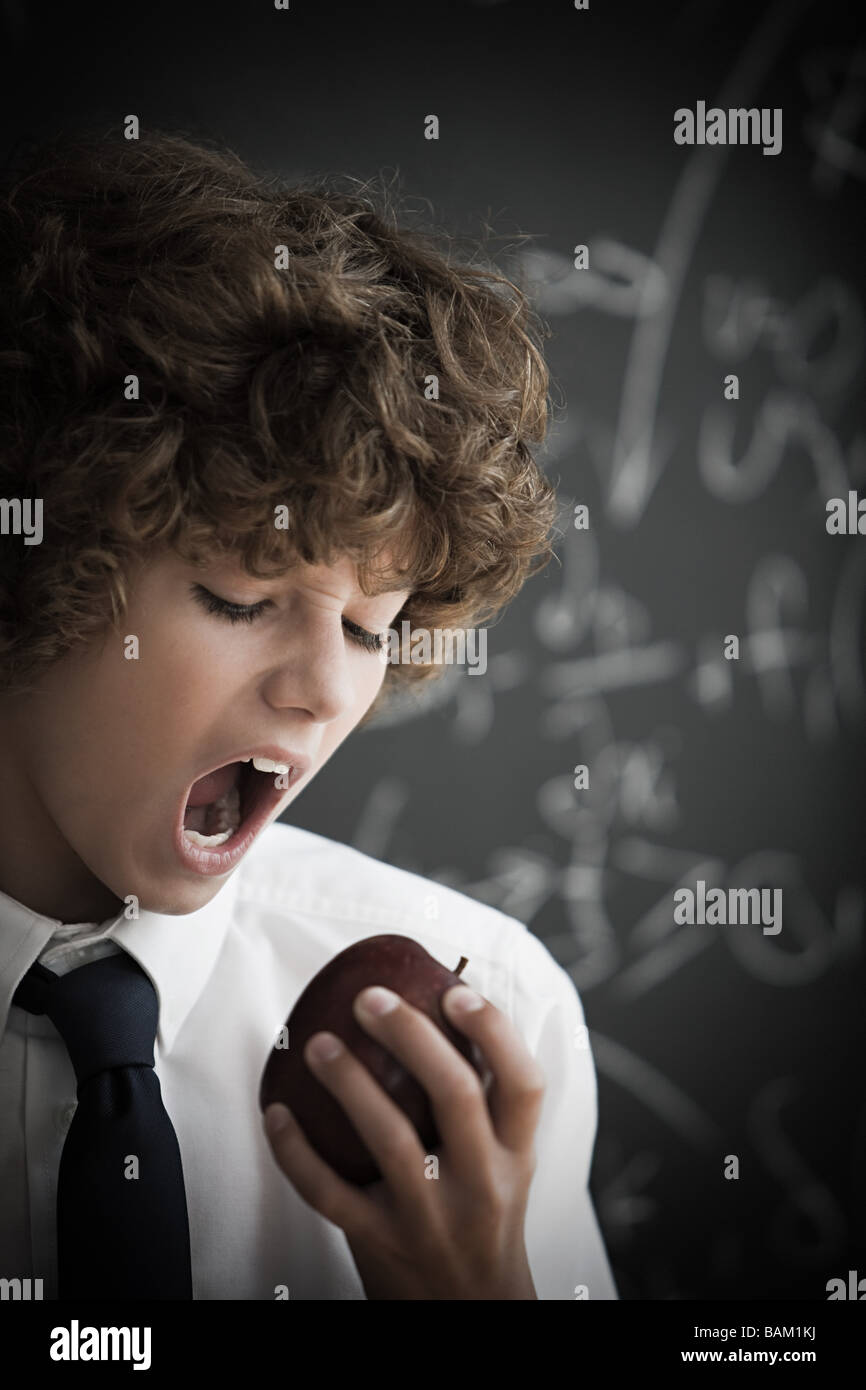 Boy eating an apple Stock Photo - Alamy