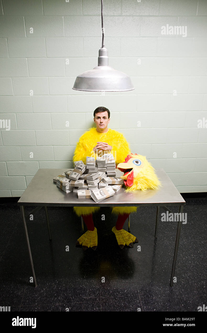 Criminal in chicken suit with money Stock Photo - Alamy