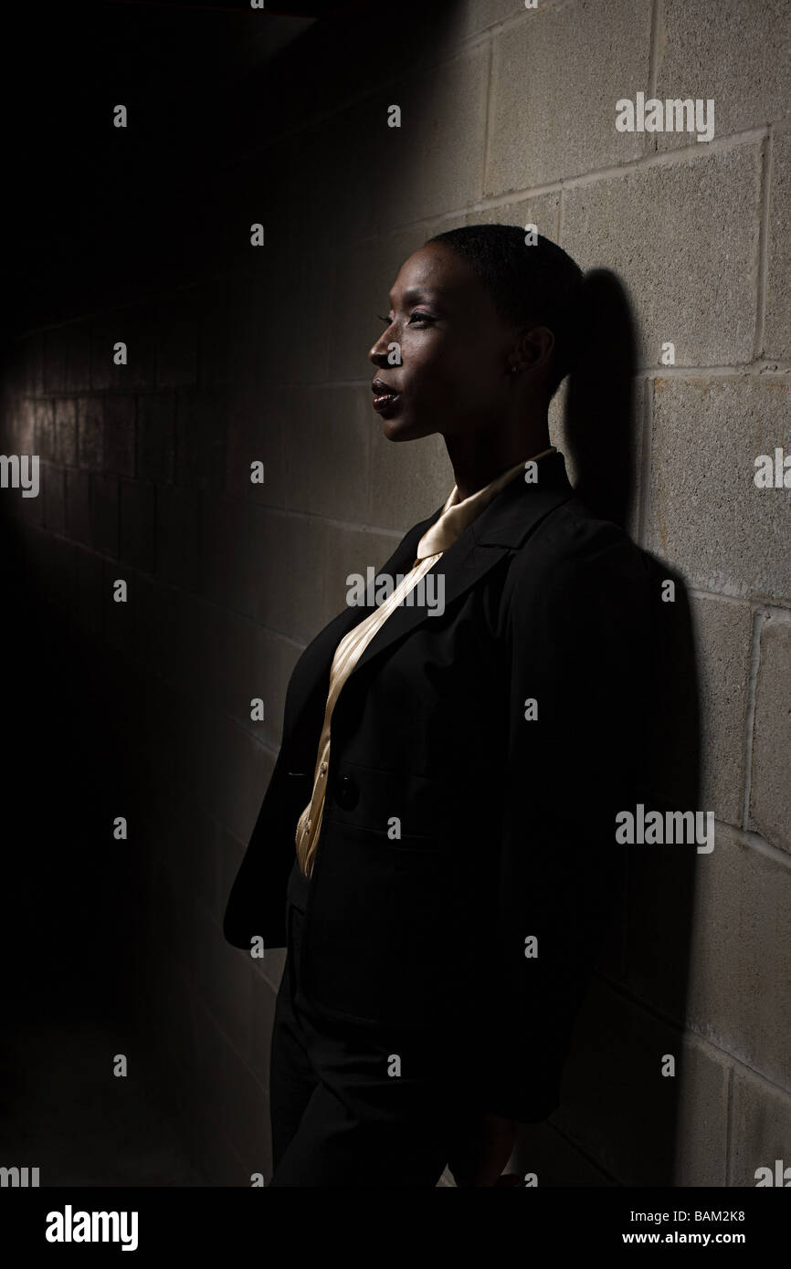 Businesswoman leaning on wall Stock Photo - Alamy