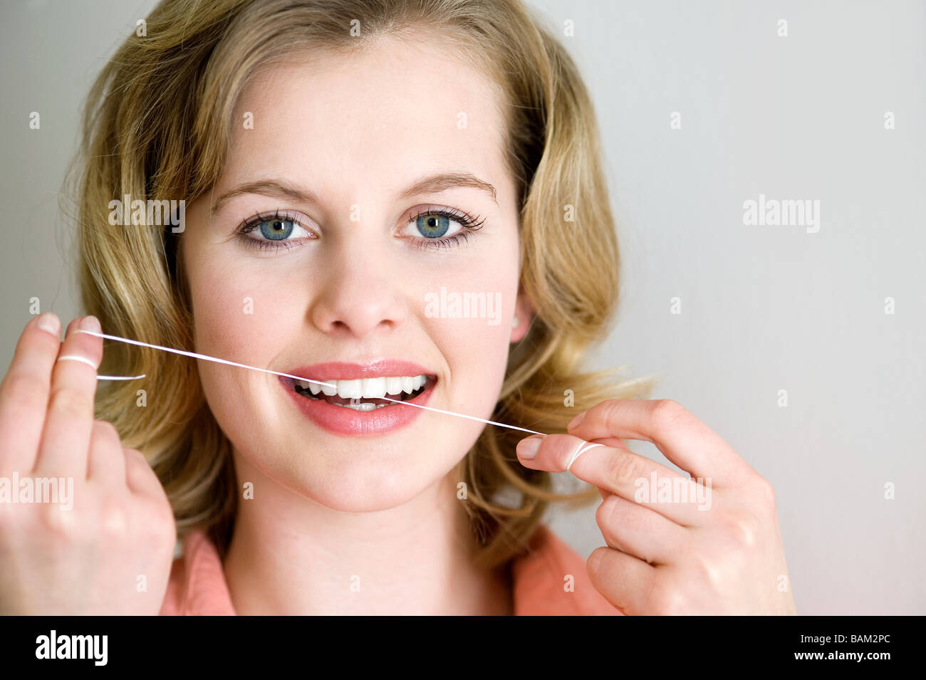 Woman with dental floss Stock Photo - Alamy