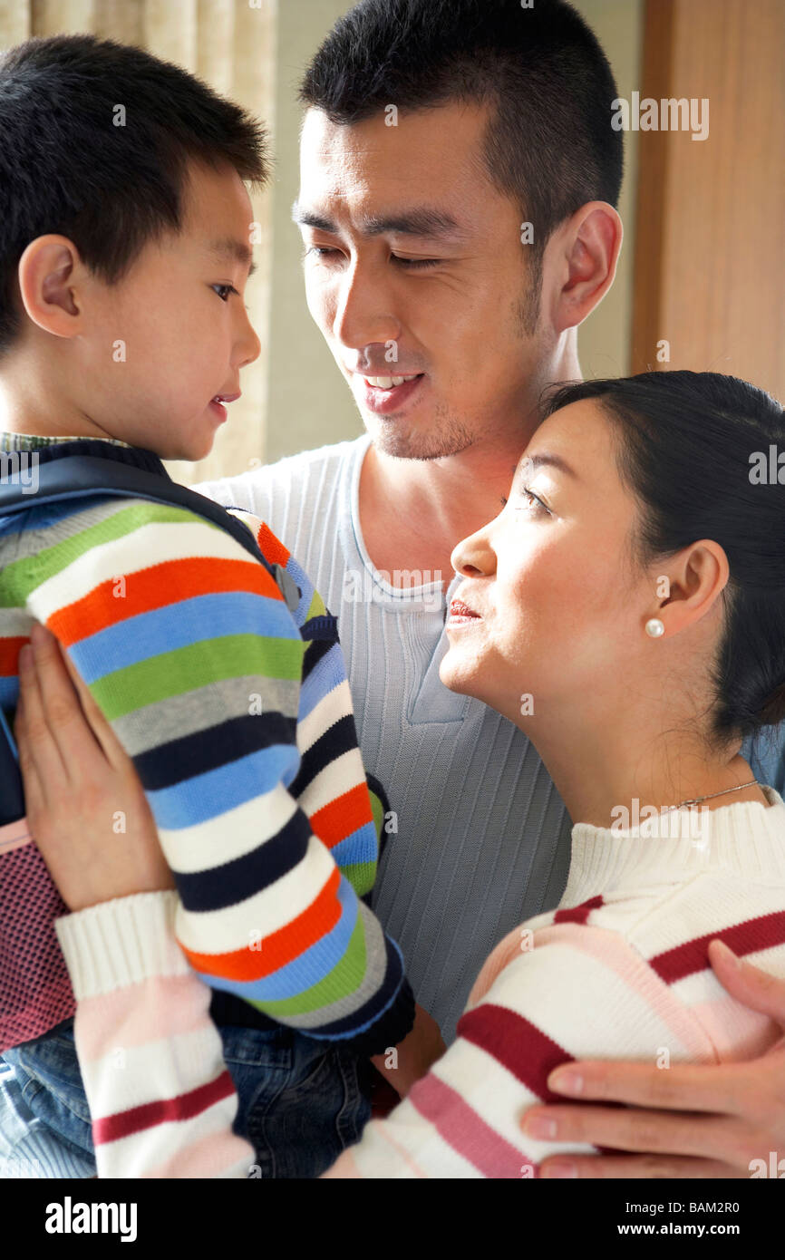 Parents Hugging Child Stock Photo - Alamy