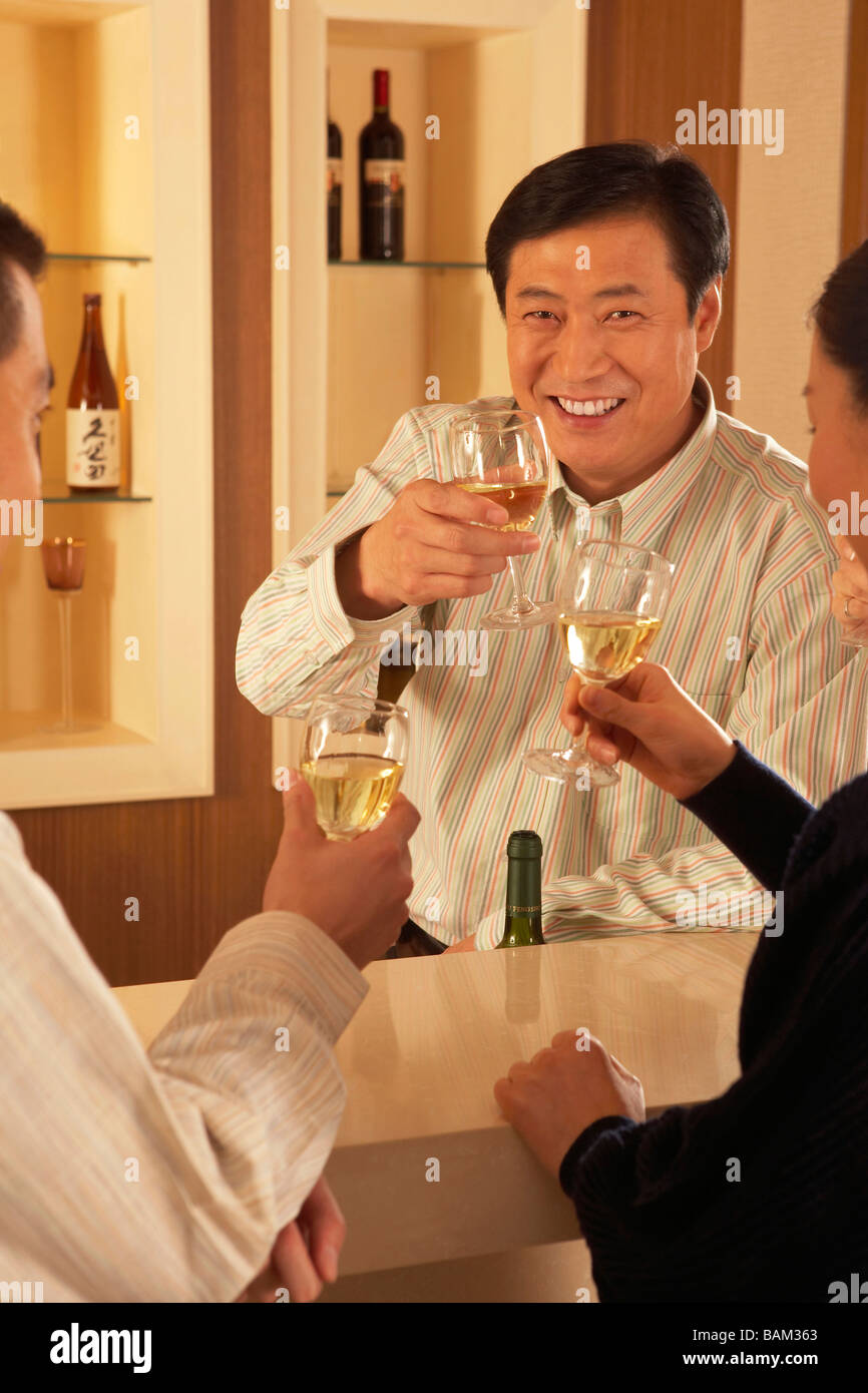 Adults Standing Around Bar Drinking Wine Stock Photo - Alamy