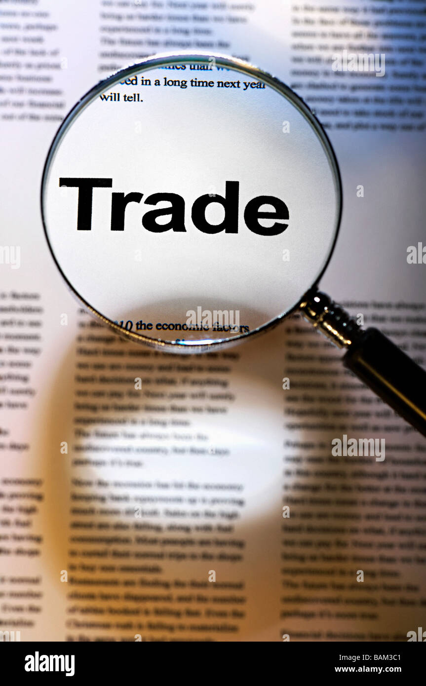 Word trade under magnifying glass Stock Photo - Alamy