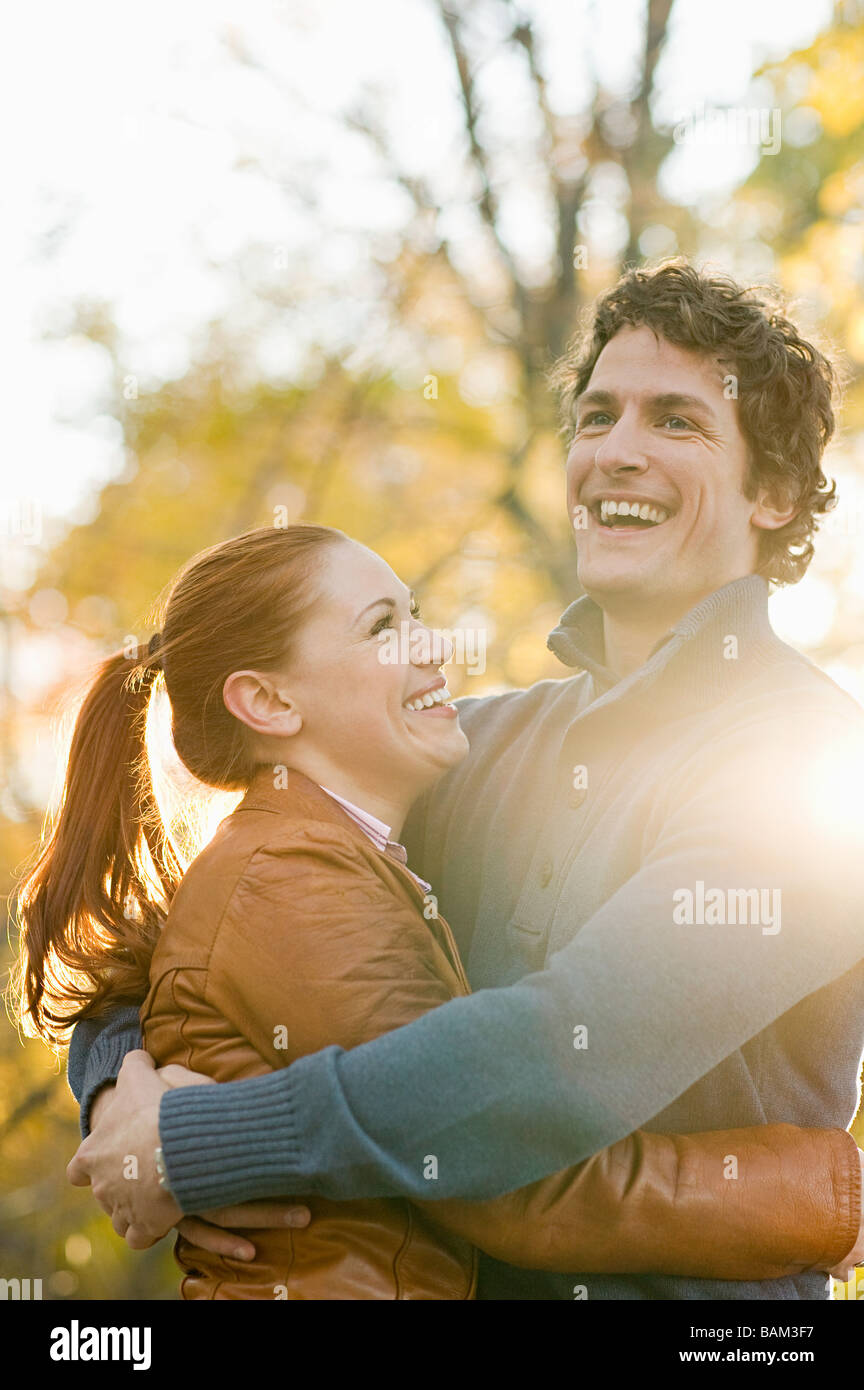Couple hugging in park Stock Photo - Alamy