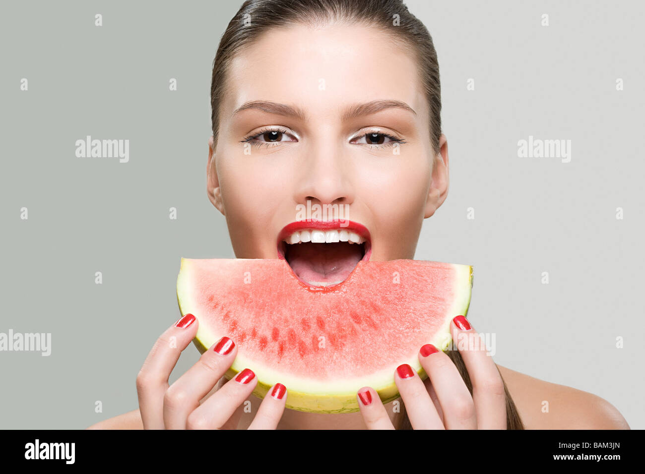 Young woman eating watermelon Stock Photo - Alamy