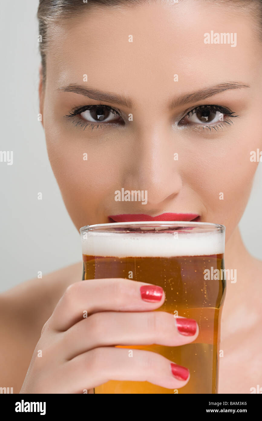 Woman drinking a pint of lager Stock Photo - Alamy
