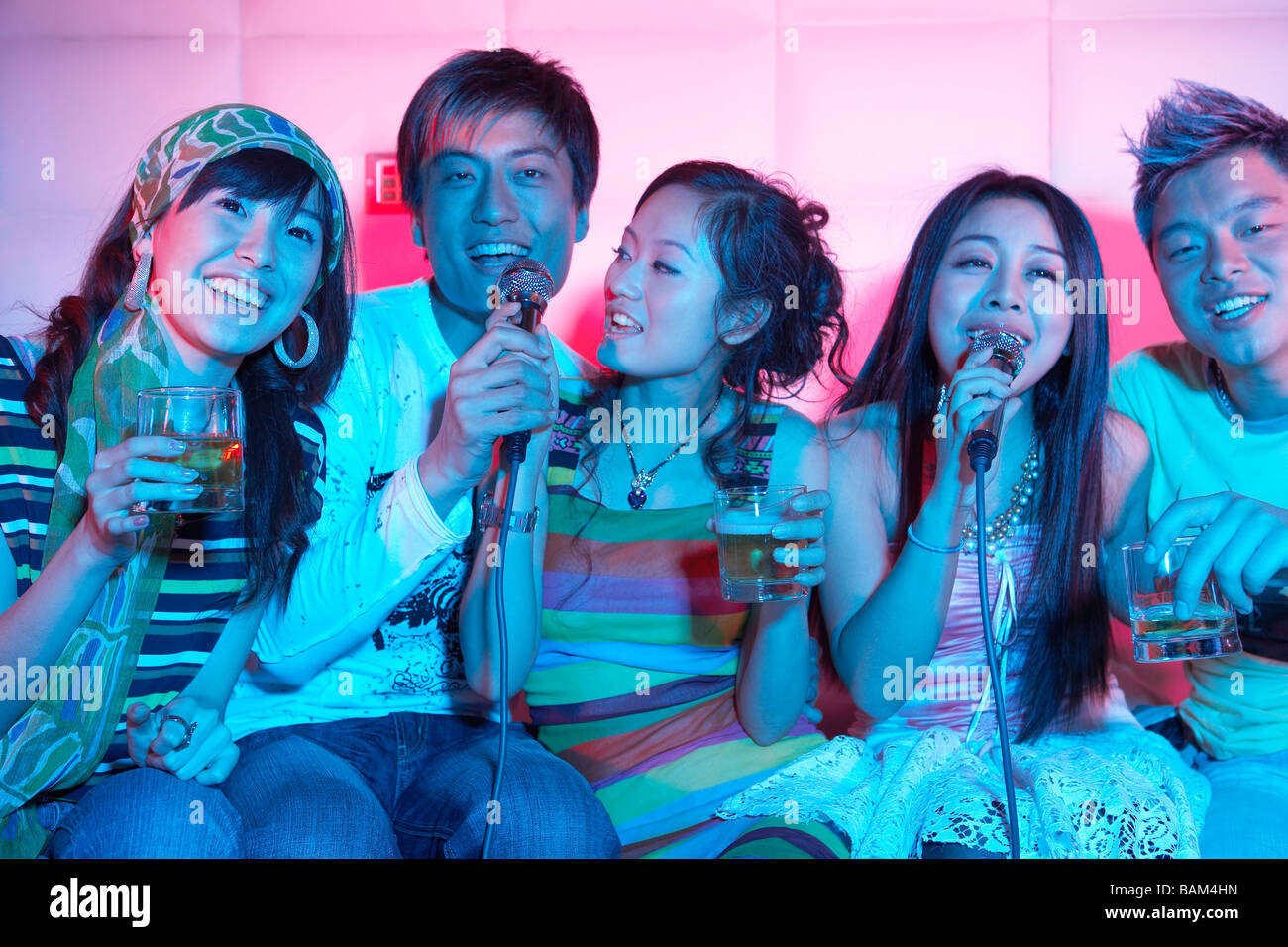 Group Of Young People Singing Karaoke Stock Photo - Alamy
