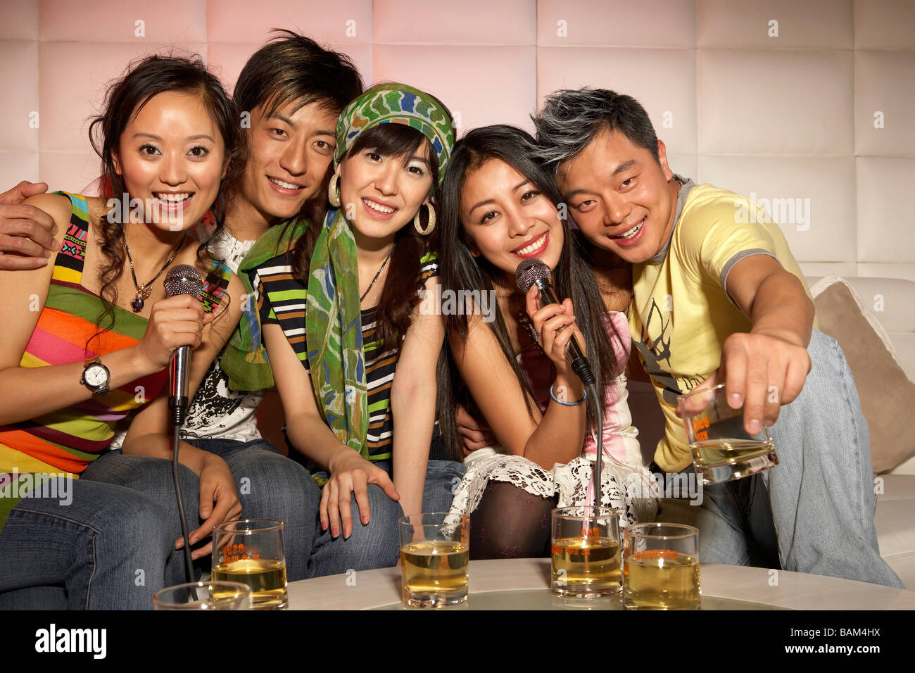 Group Of Young People Singing Karaoke Stock Photo - Alamy