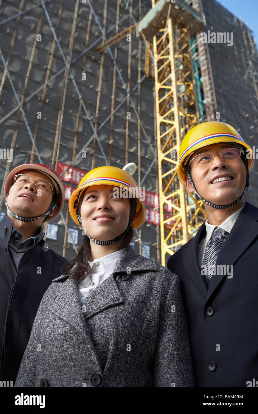 Businesspeople In Construction Site Wearing Hard Hats Stock Photo - Alamy