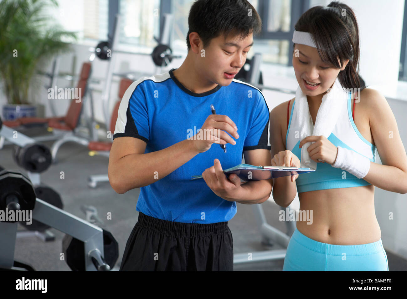 Personal trainer instructing female hi-res stock photography and images ...