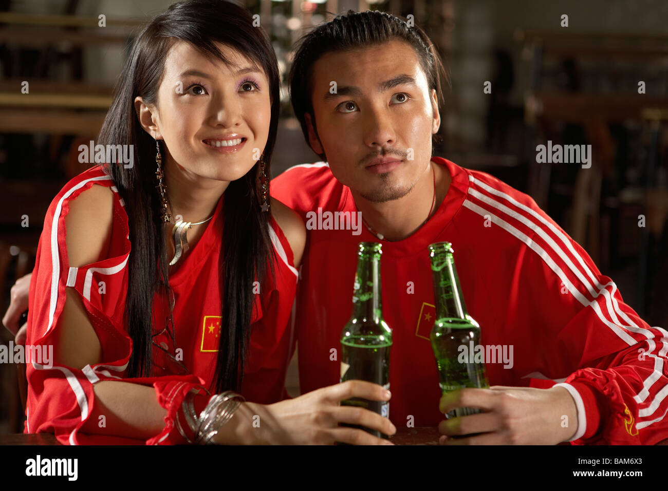 Sports Enthusiasts Watching Game In Bar Stock Photo - Alamy