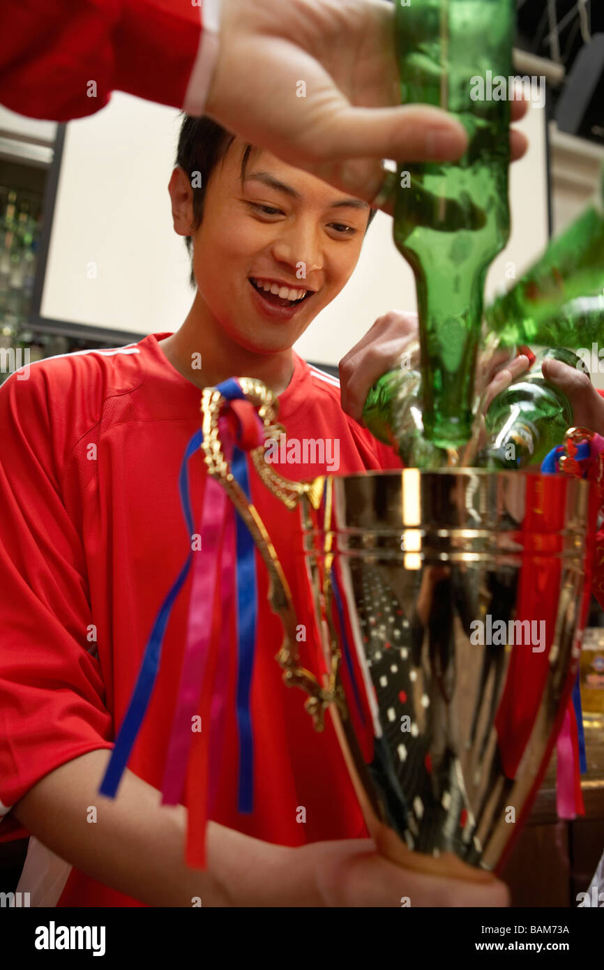 Patriotic Young Men Pouring Alcohol Into Trophy Cup Stock Photo - Alamy