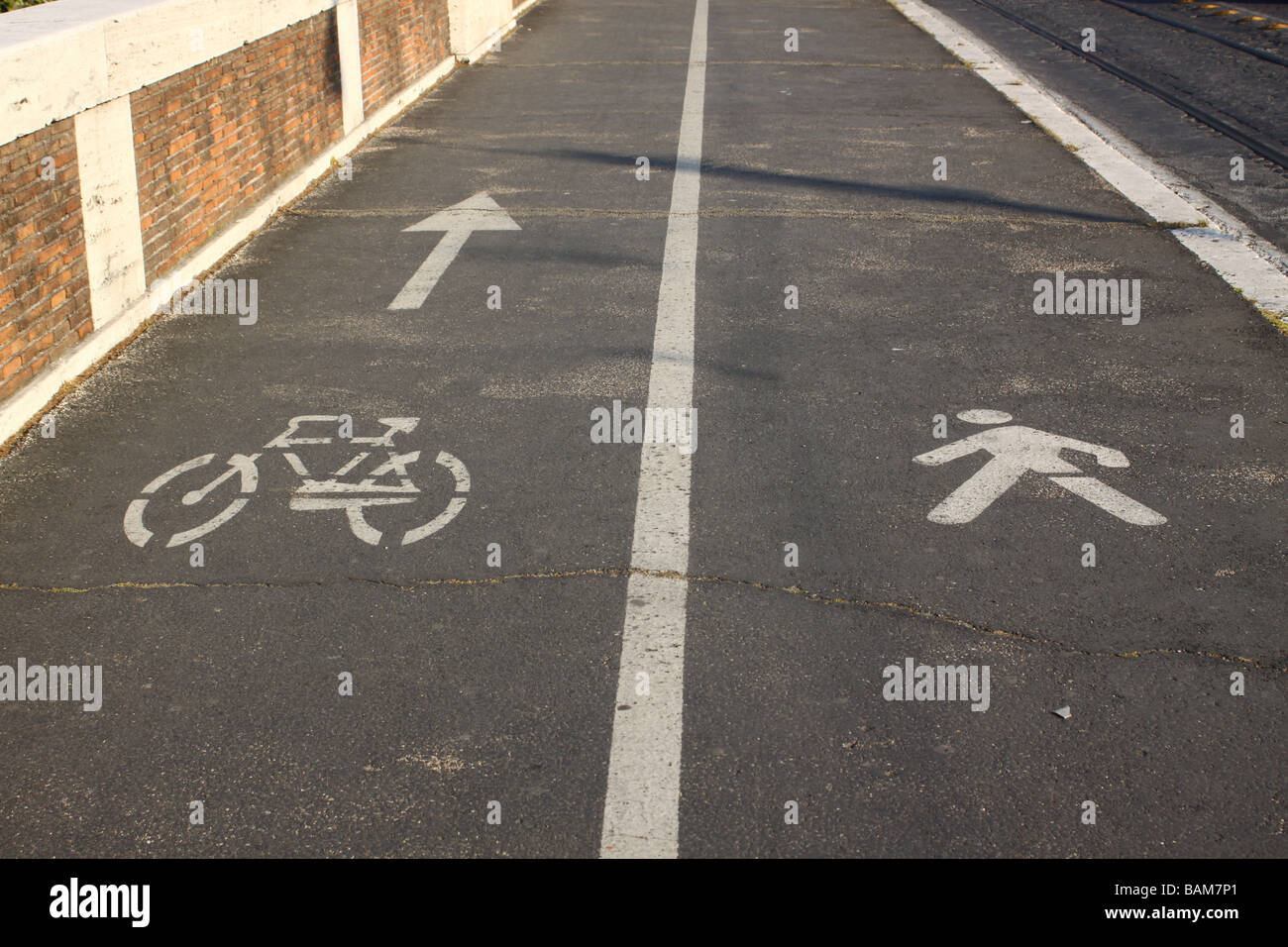 painted sign indicating cycle lane and pedestrian walkway in Rome ...