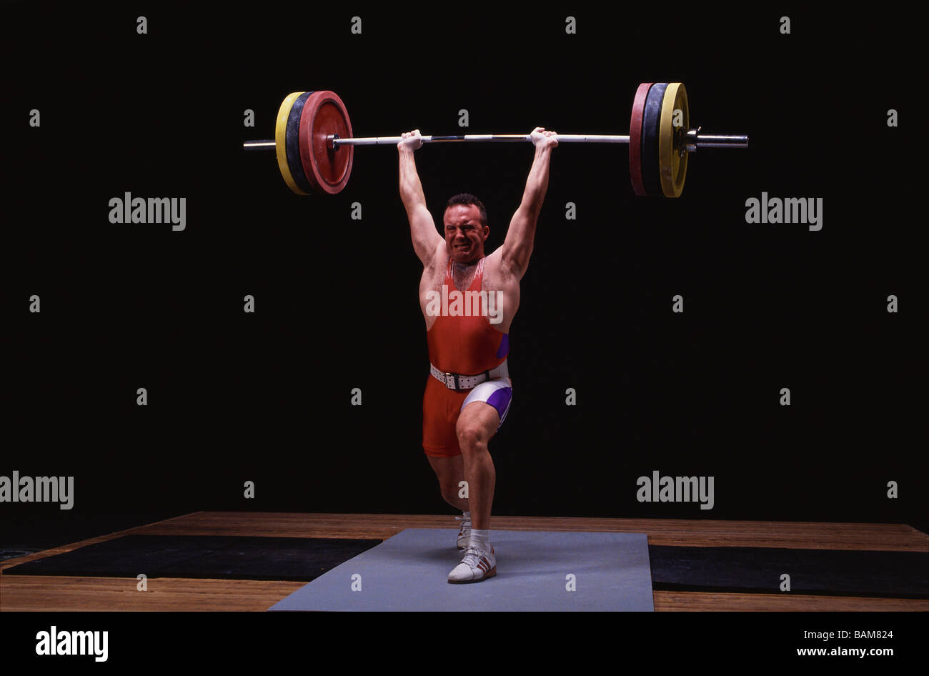 Olympic style weightlifter in action Stock Photo - Alamy