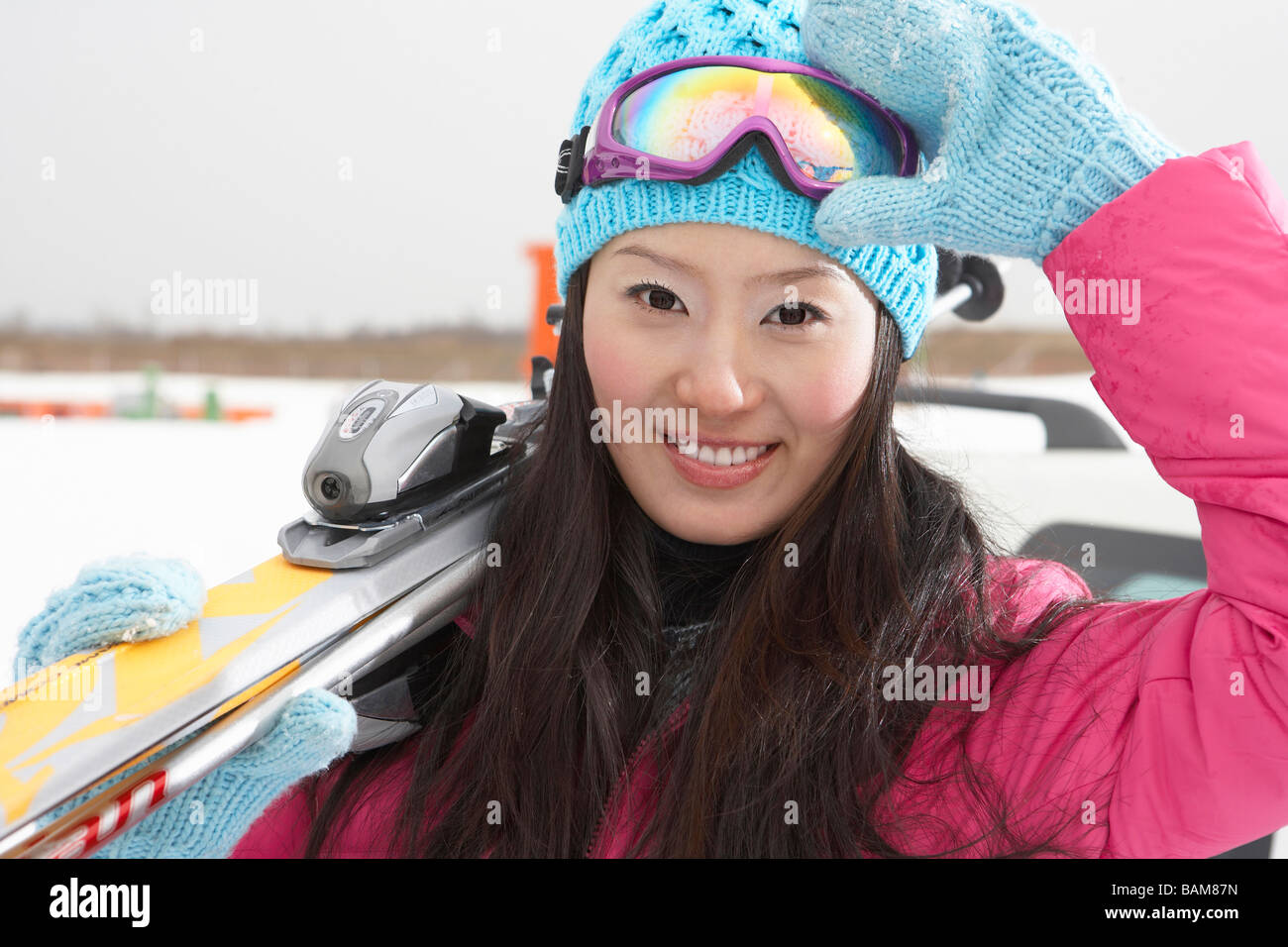 Woman Carrying Skis Stock Photo - Alamy