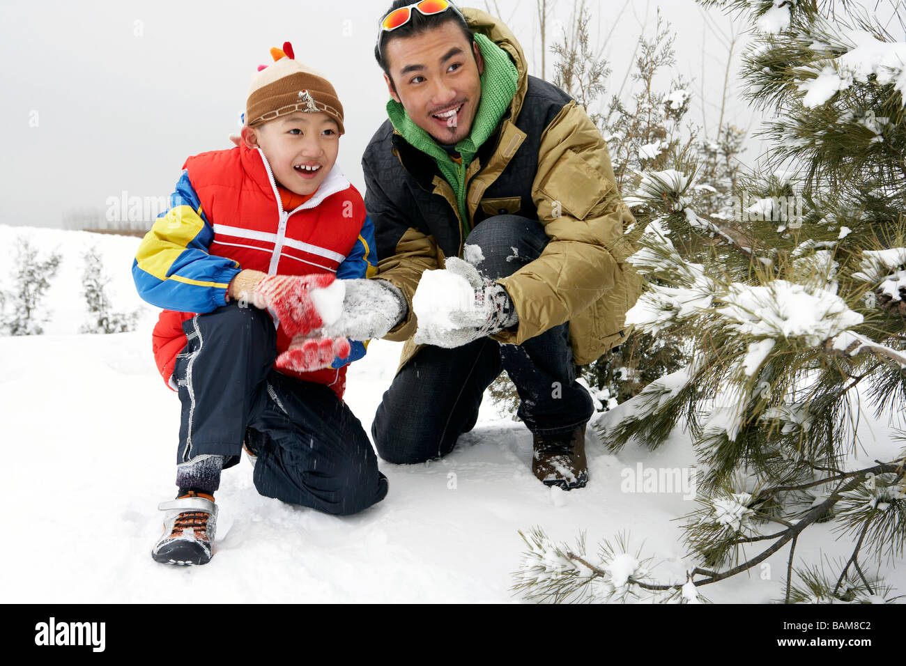 Two boys hiding behind tree hi-res stock photography and images - Alamy