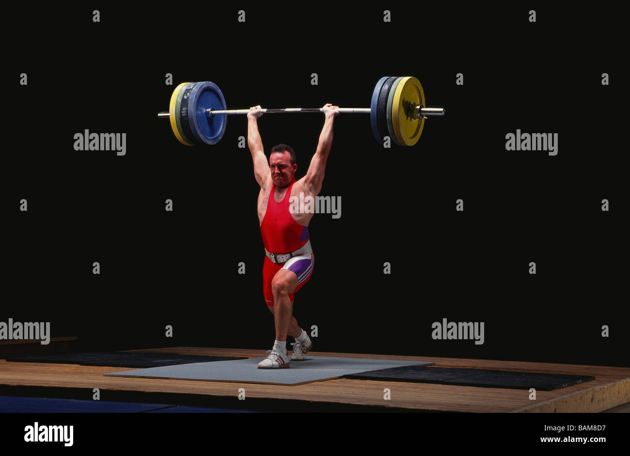 Olympic style weightlifter in action Stock Photo - Alamy