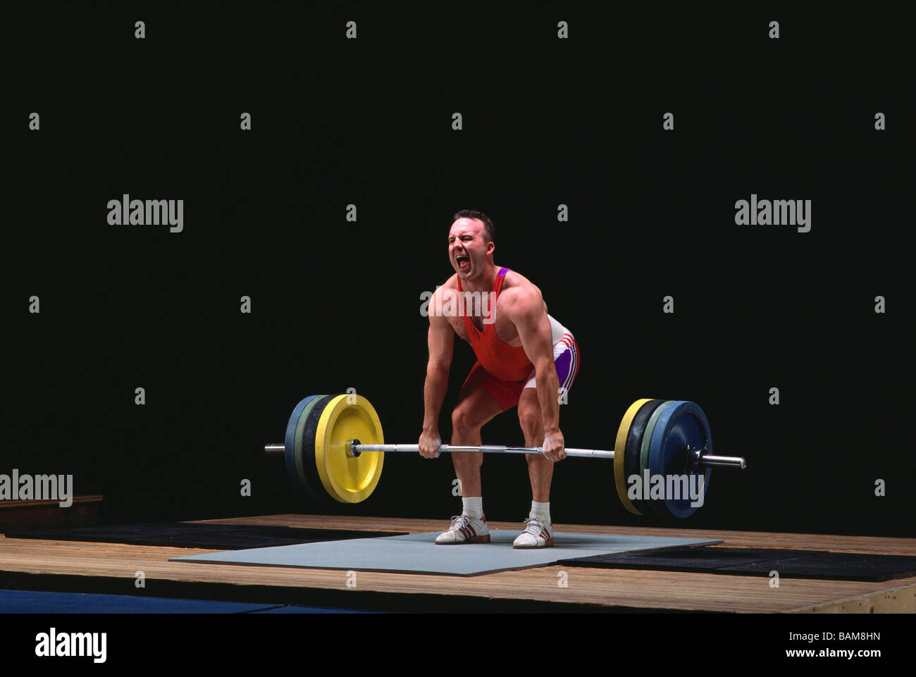 Olympic style weightlifter in action Stock Photo - Alamy