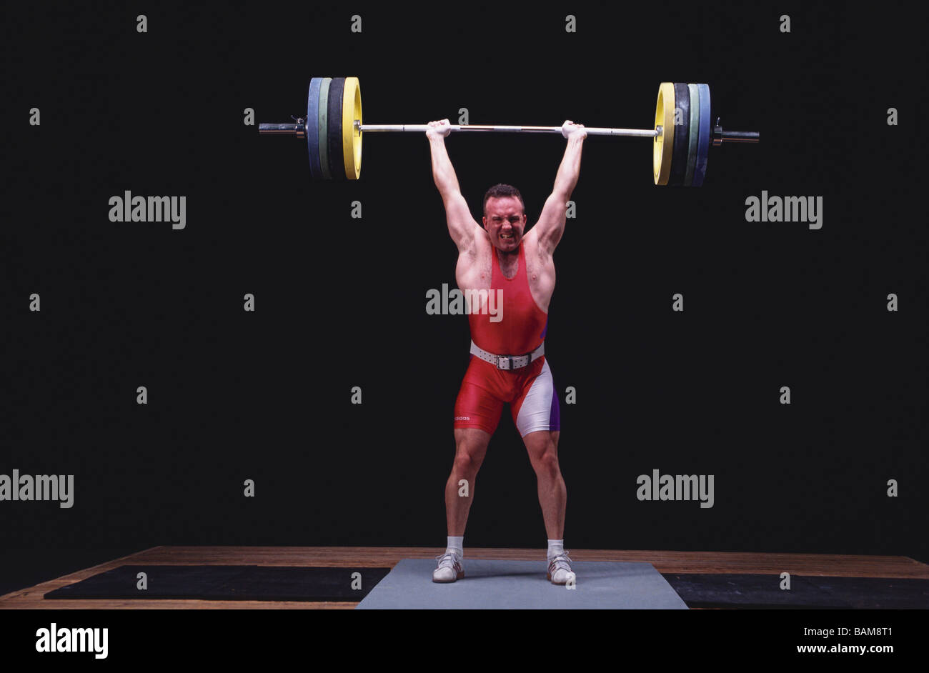 Olympic style weightlifter in action Stock Photo - Alamy