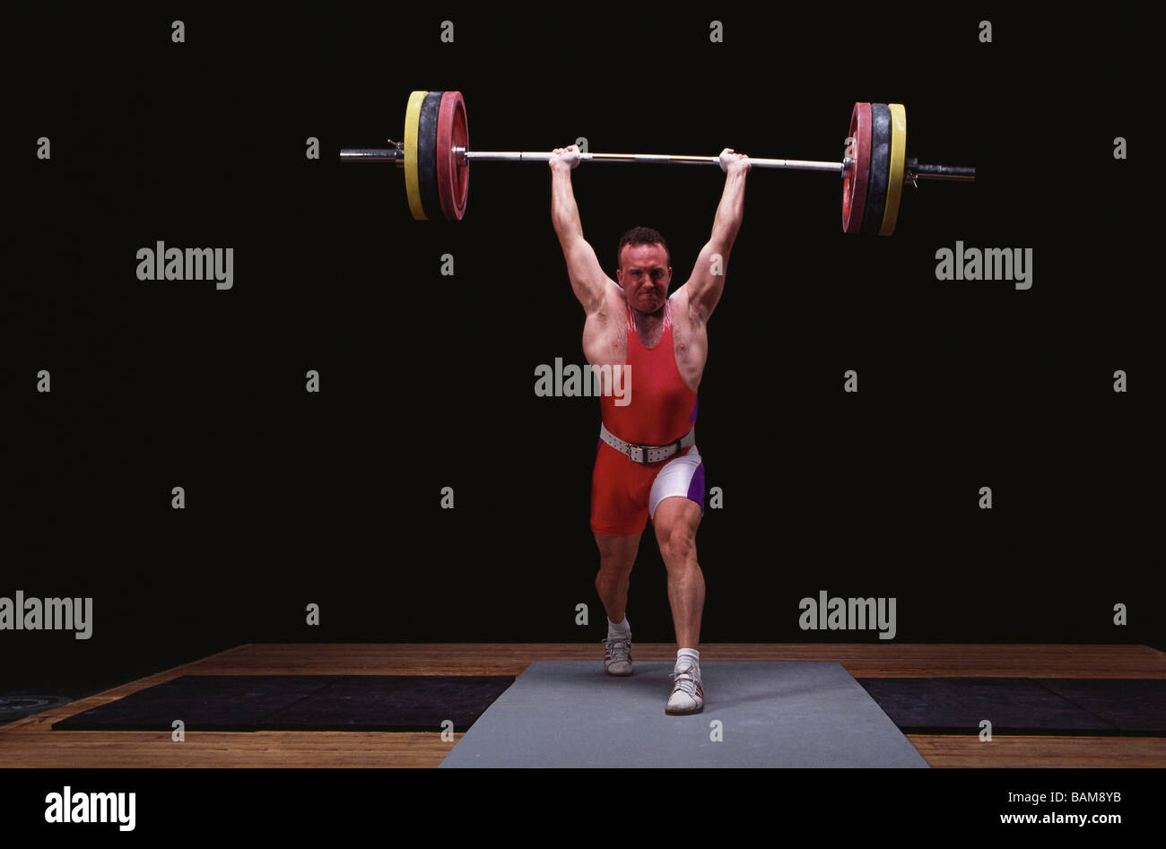 Olympic style weightlifter in action Stock Photo - Alamy