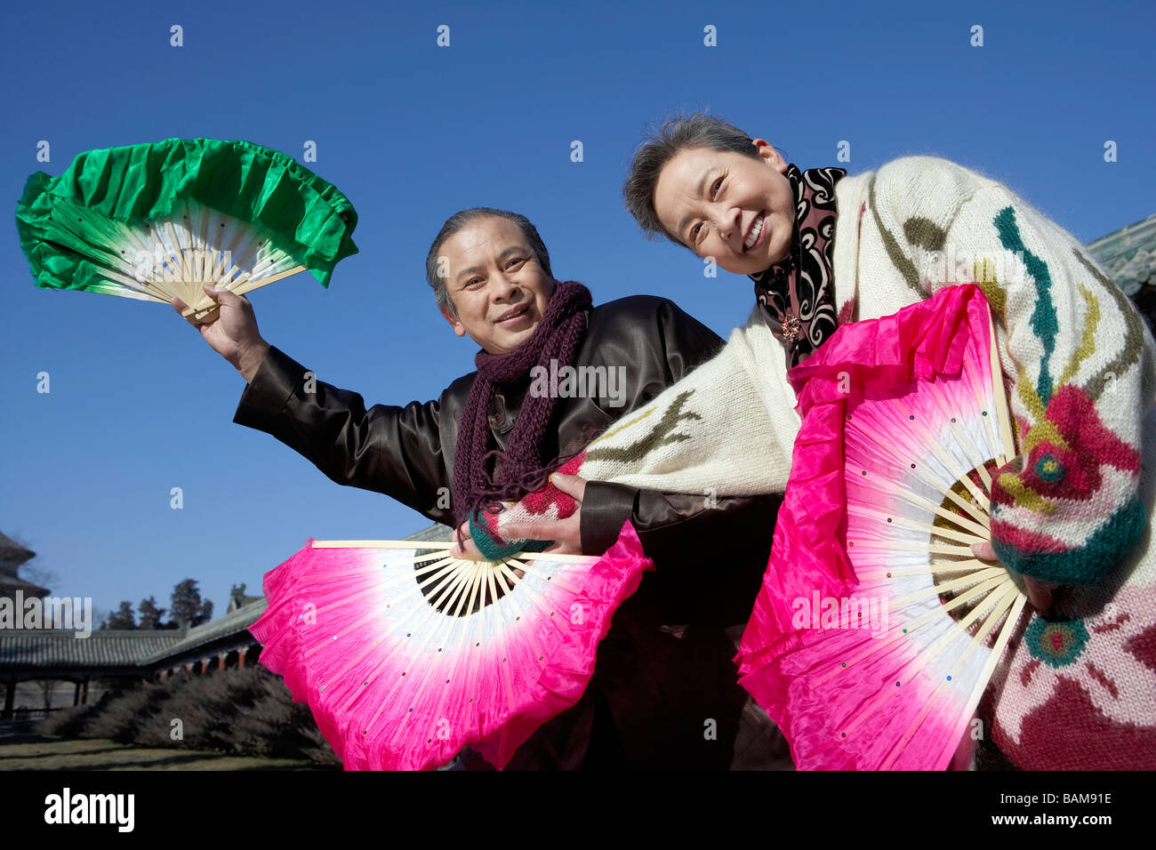 Elderly Couple Holding Fans Stock Photo - Alamy