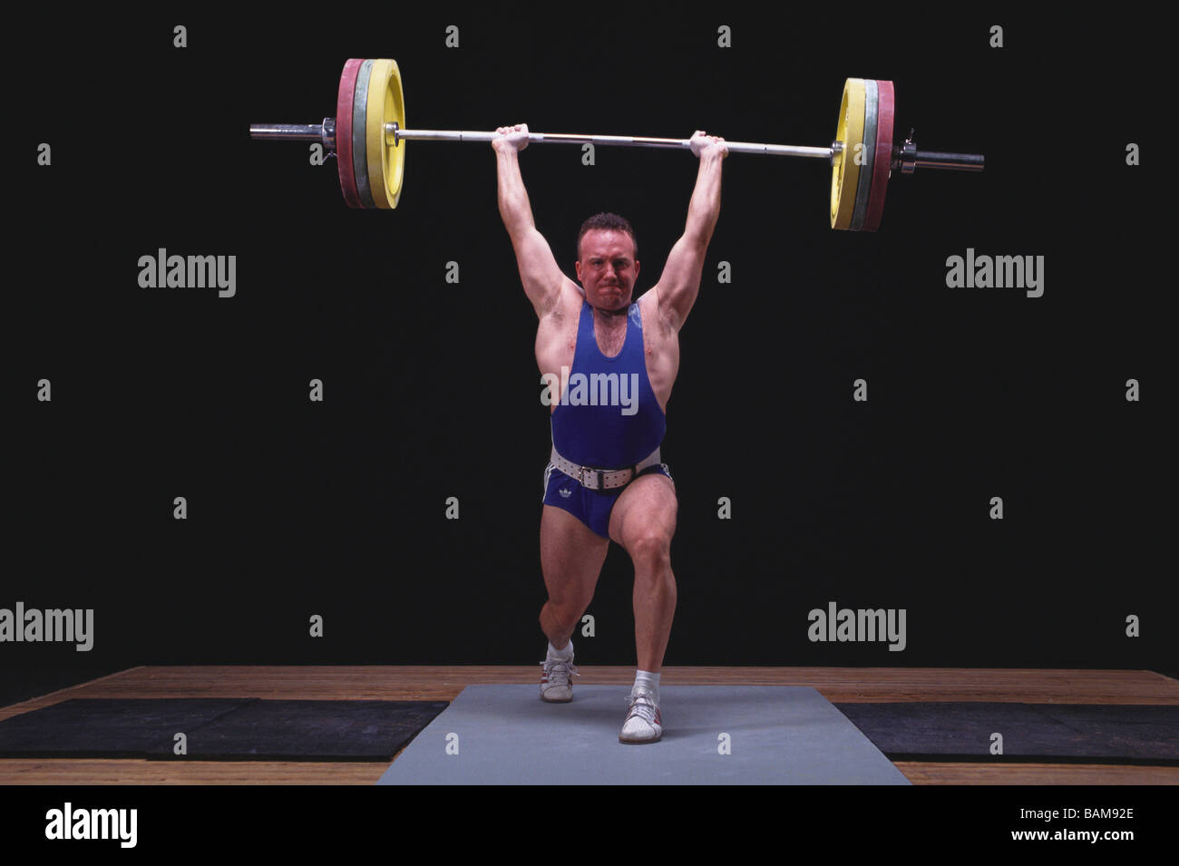 Olympic style weightlifter in action Stock Photo - Alamy