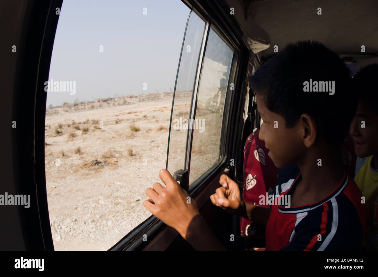 children look out of bus window in asia Stock Photo - Alamy