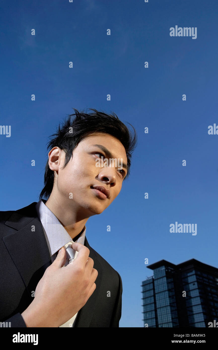 Young Businessman Staring Confidently Into The Distance Stock Photo - Alamy