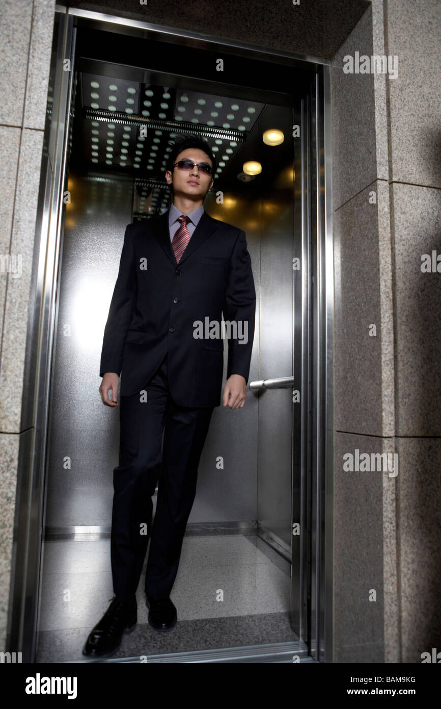 Man Walking Out Of Elevator Stock Photo - Alamy