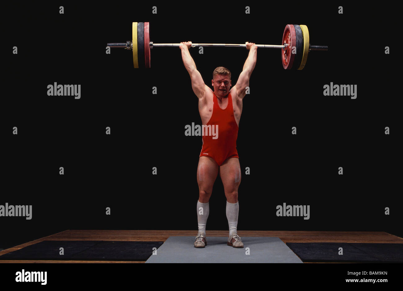 Olympic style weightlifter in action Stock Photo - Alamy