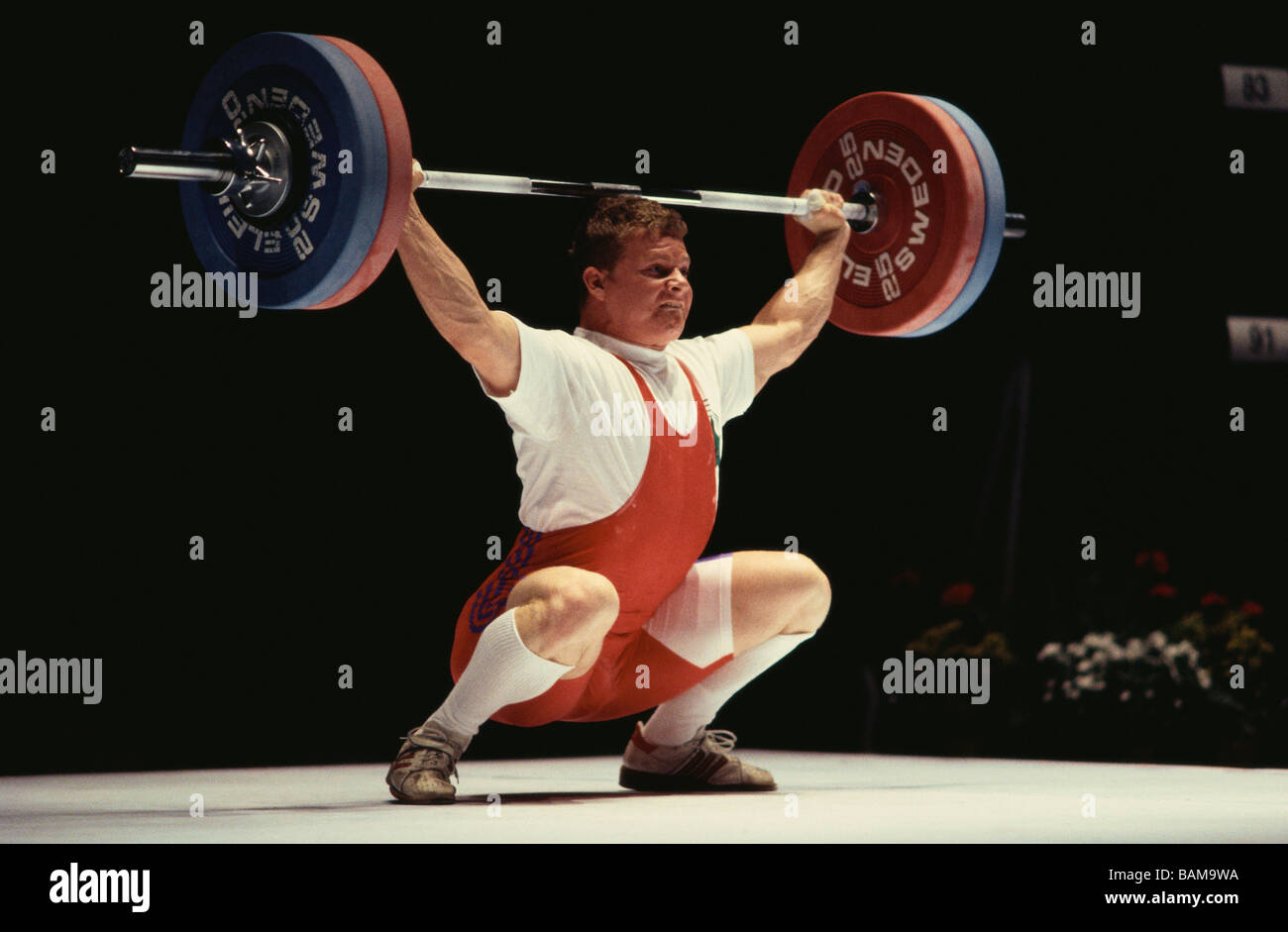 Olympic style weightlifter in action Stock Photo - Alamy