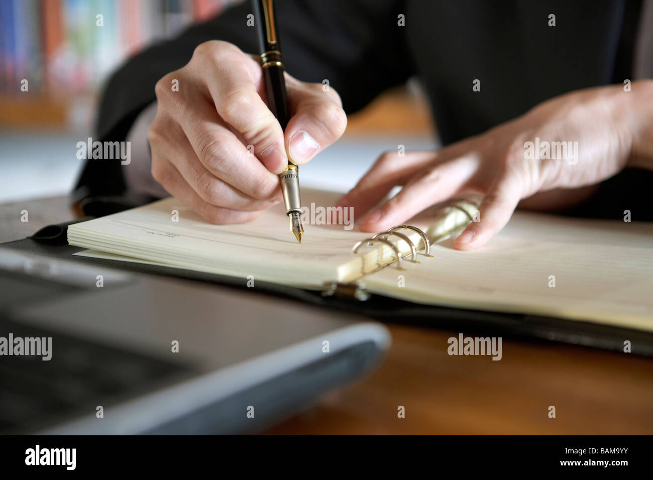 Businessman Writing In A Book Stock Photo - Alamy